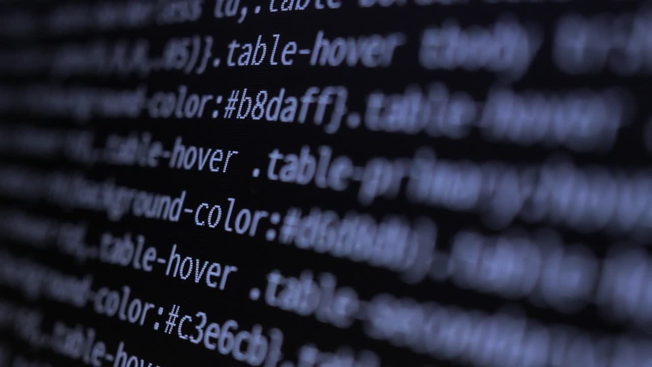 Premium stock video - 4k close-up shot programming tag code on pc monitor scroll down