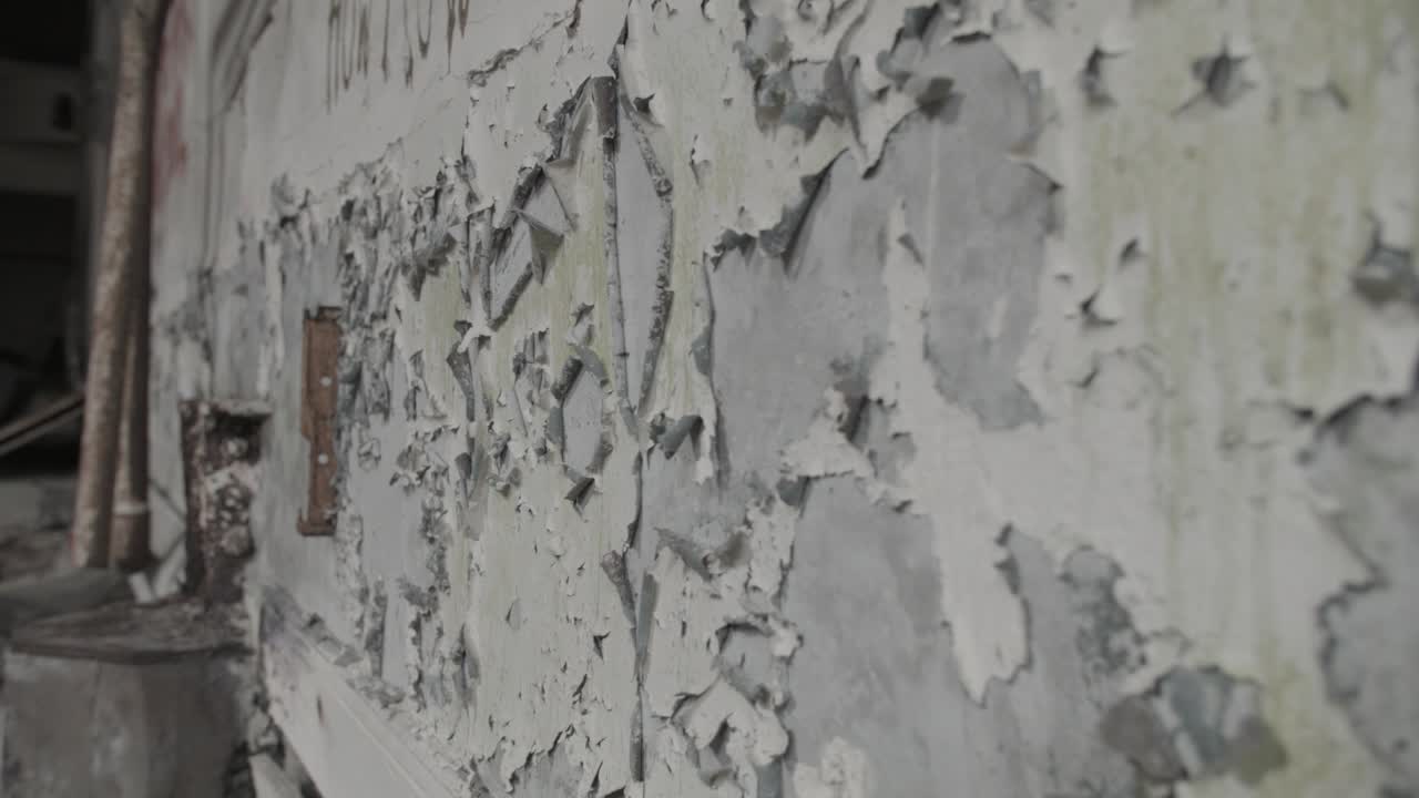 Premium stock video - Grungy flaking paint on abandoned building wall