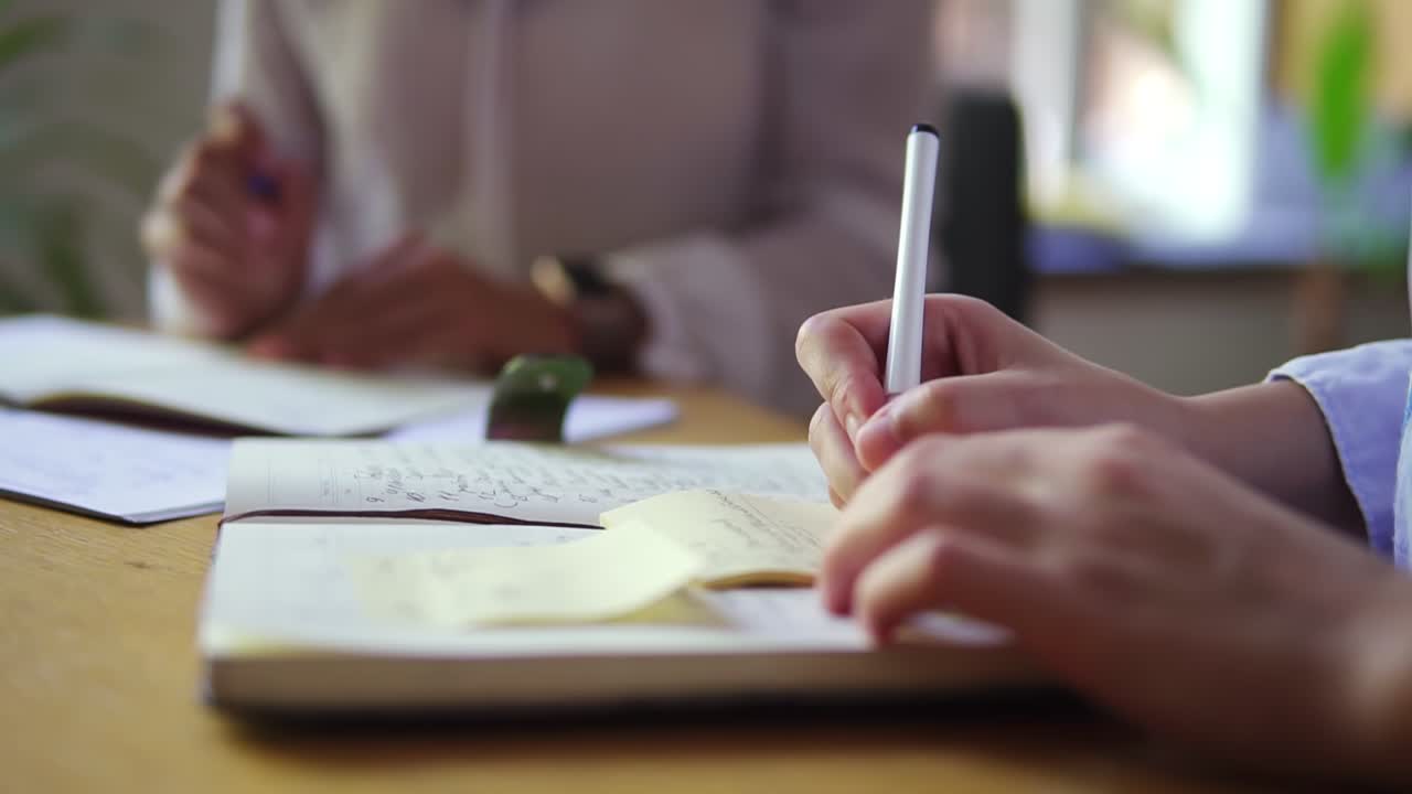 Free stock video - A female hand writing notes in notepad