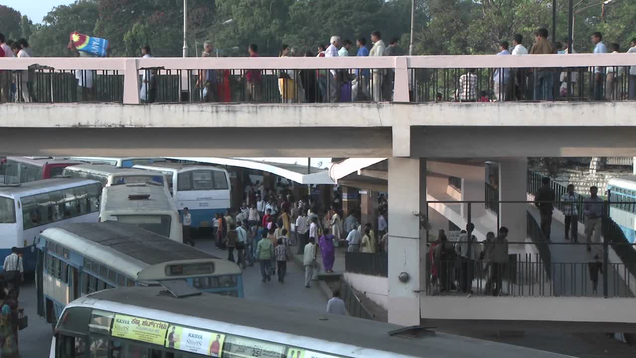 Premium stock video - People gather in a bus station getting on and off ...