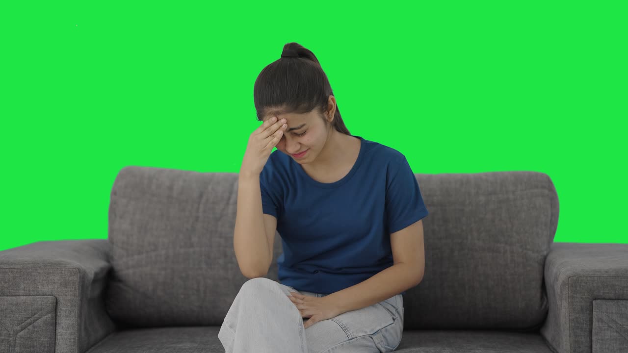 Sick indian teenage girl having a headache green screen Premium Stock ...