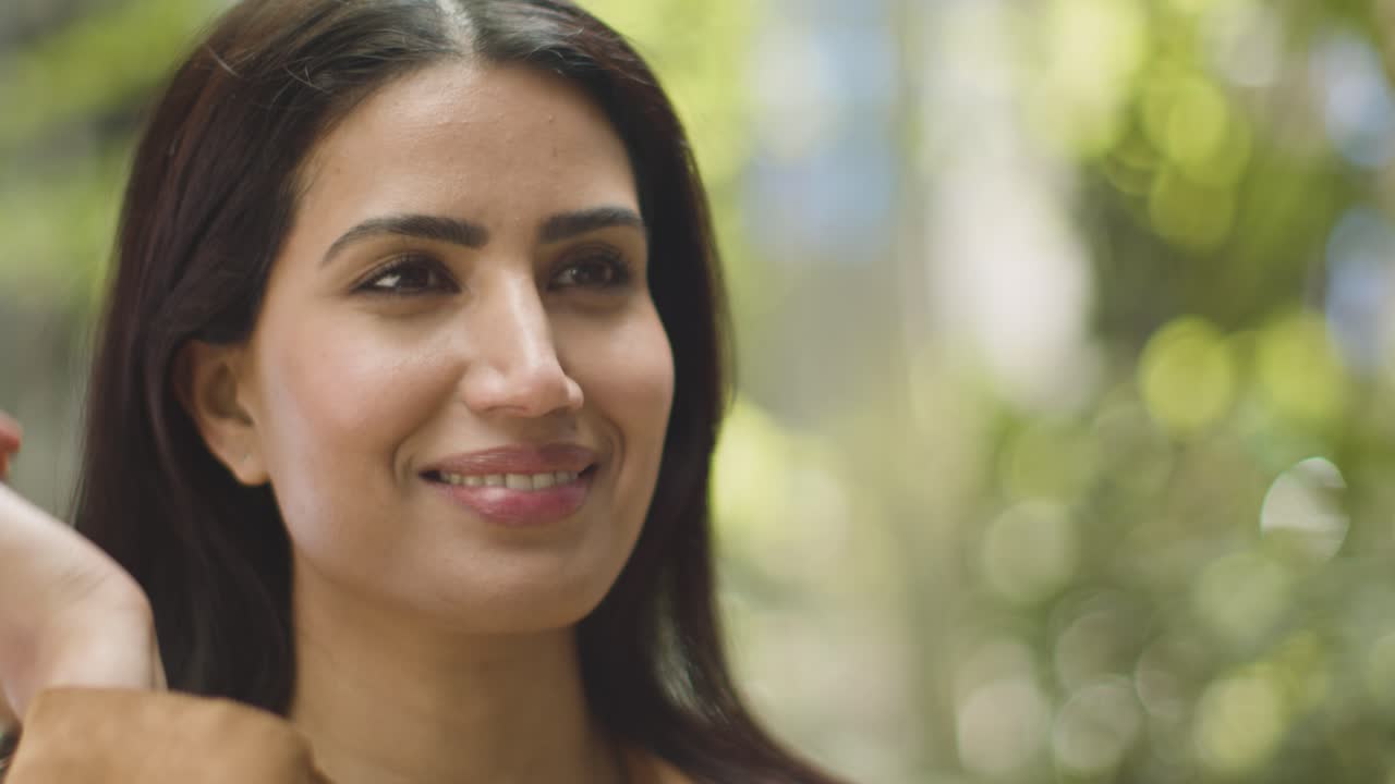Close up of muslim couple on date meeting and talking on city street ...