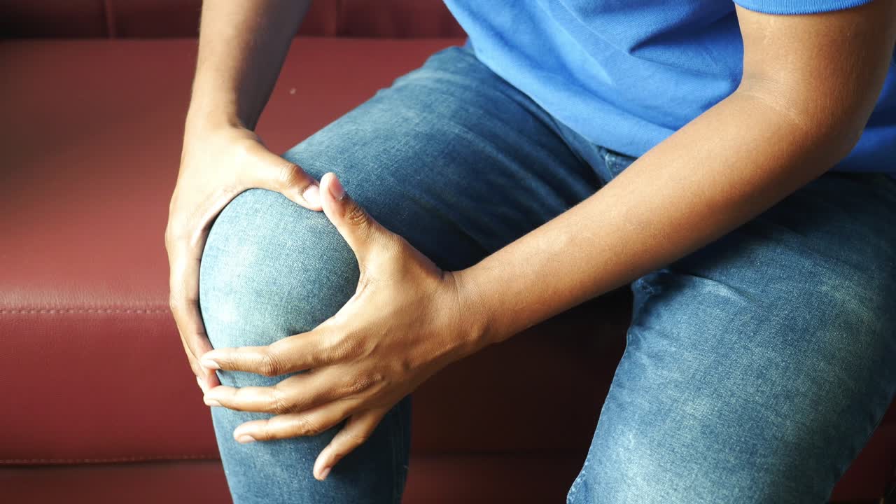 Premium stock video - Close up on man suffering knee joint pain