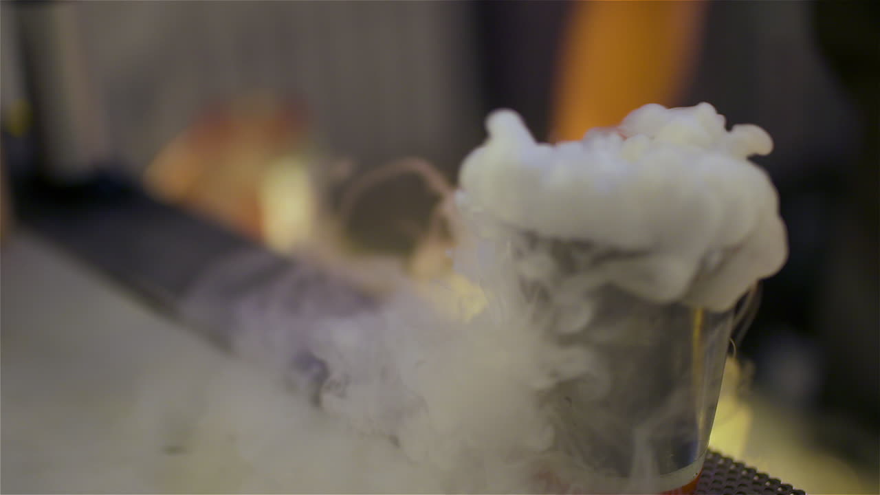 Free stock video - Bartender preparing dry ice drink at club 3