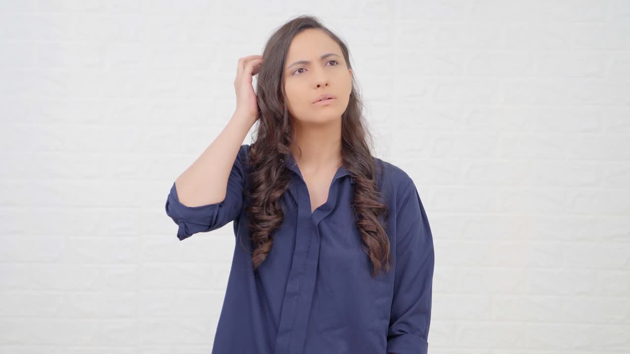 Confused indian girl thinking hard Premium Stock Video Footage