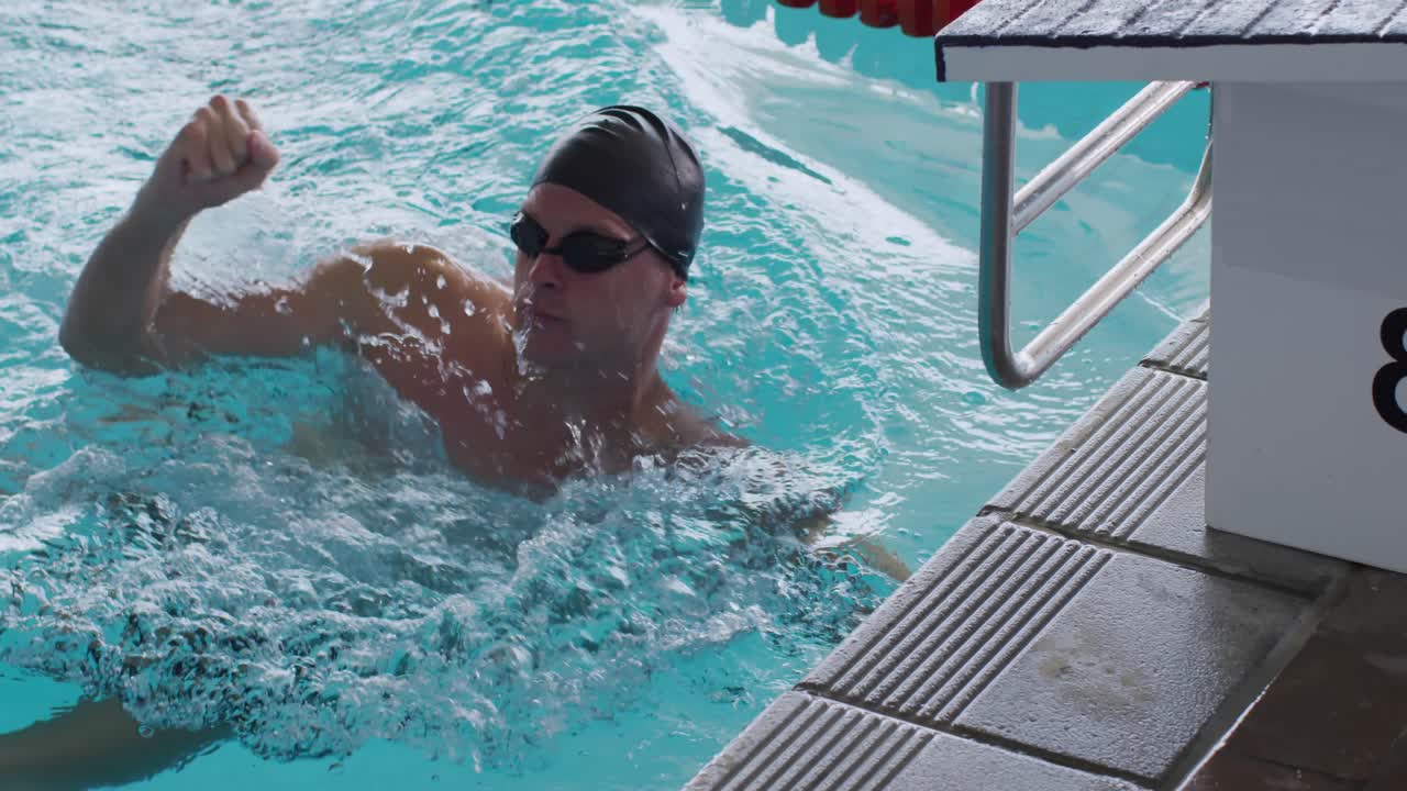 Premium stock video - Swimmer swimming into the pool