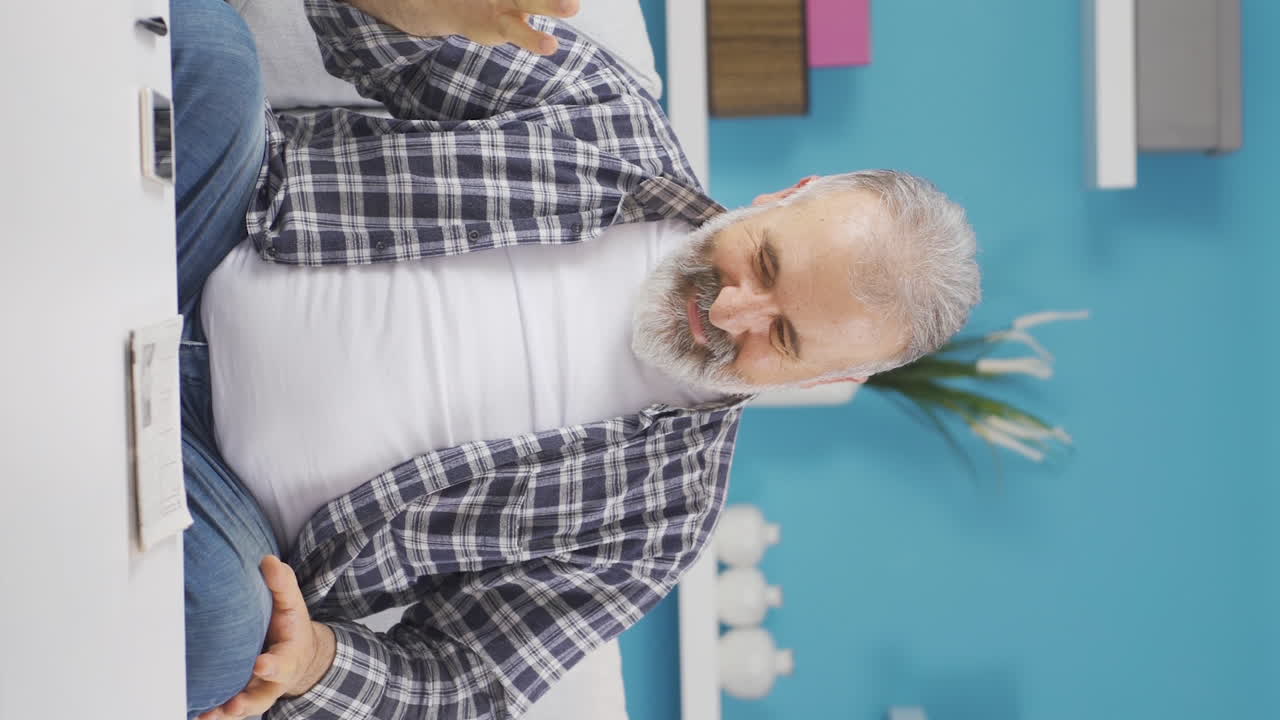 Premium stock video - Vertical video of disgusted old man.