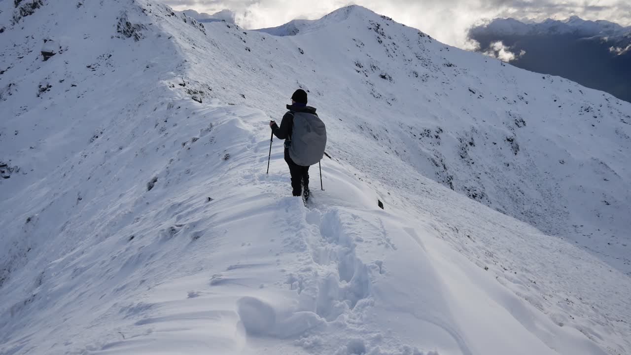 Woman Hiker Crosses A Snowy Ridge In High Altitude In The Kepler Track ...