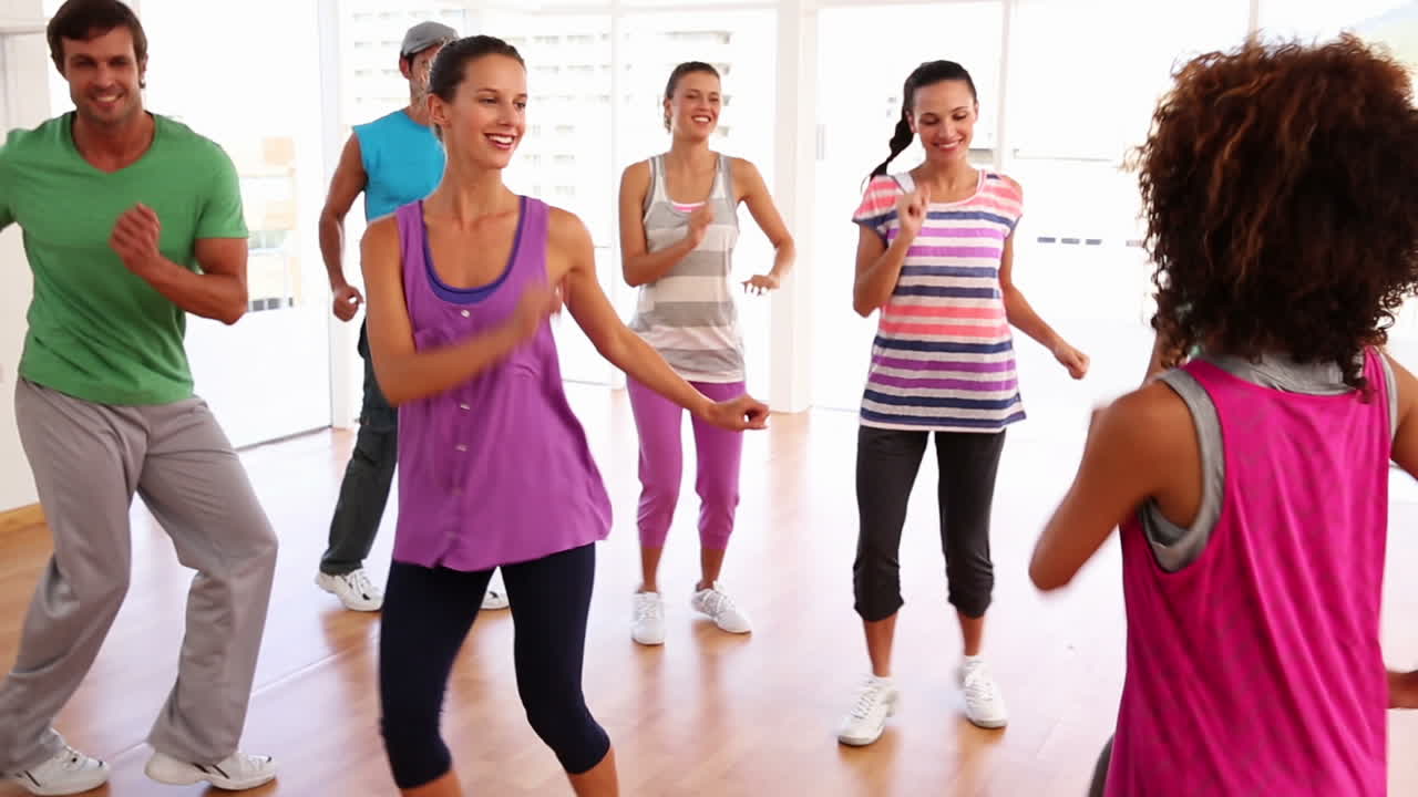 Premium stock video - Zumba class dancing in studio