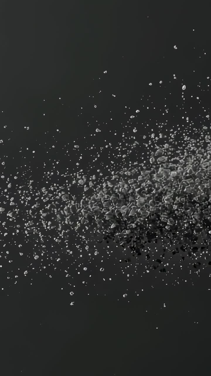 Vertical video: Particle cloud bursting then thinning in void after ...
