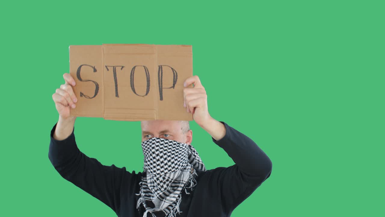 Bald revolutionist in checkered bandana showing cardboard with stop ...