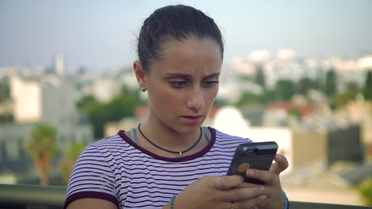 Premium stock video - Free spirited teenage girl texting surprised ...