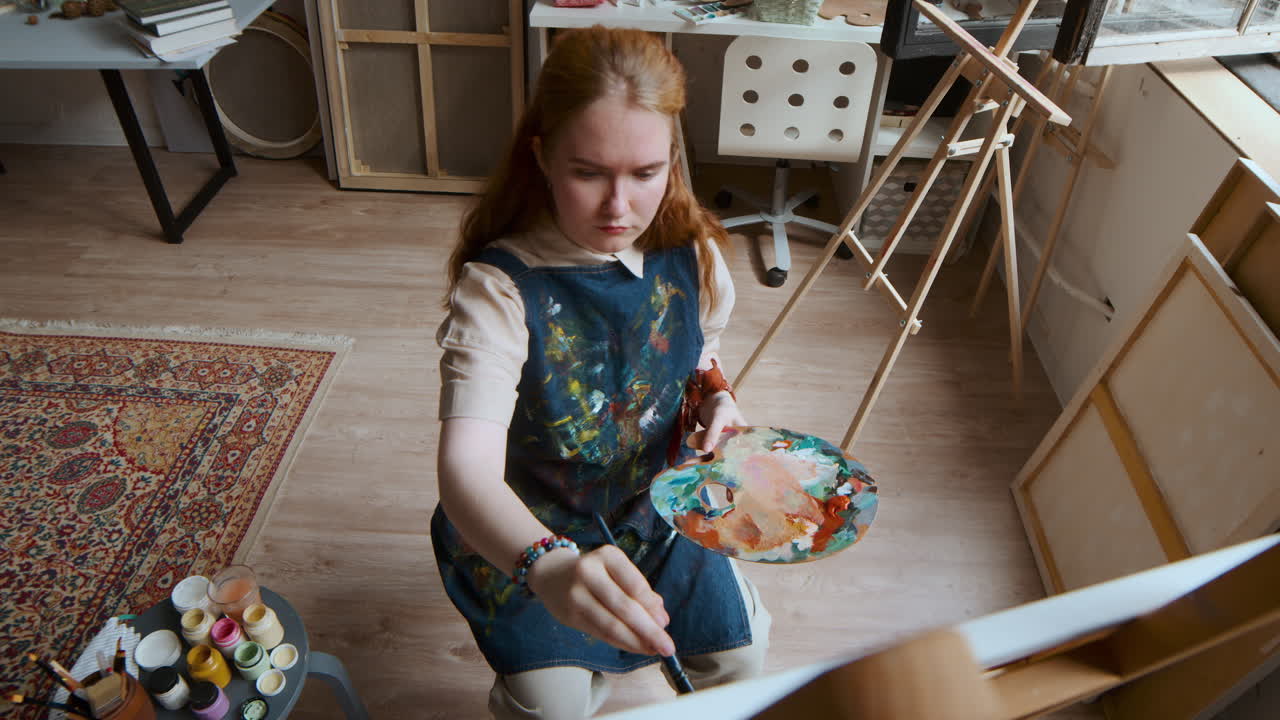 Free stock video - Artist painting on a canvas