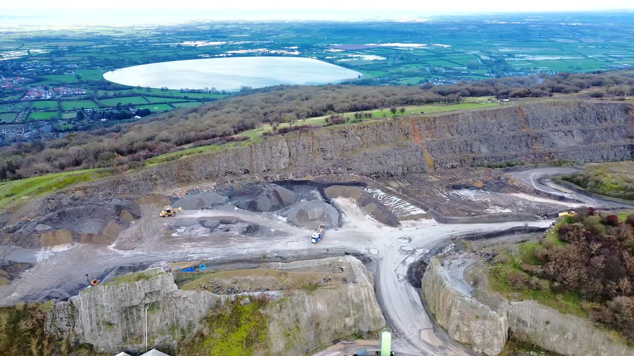 Premium stock video - Quarry mining with cheddar reservoir in background