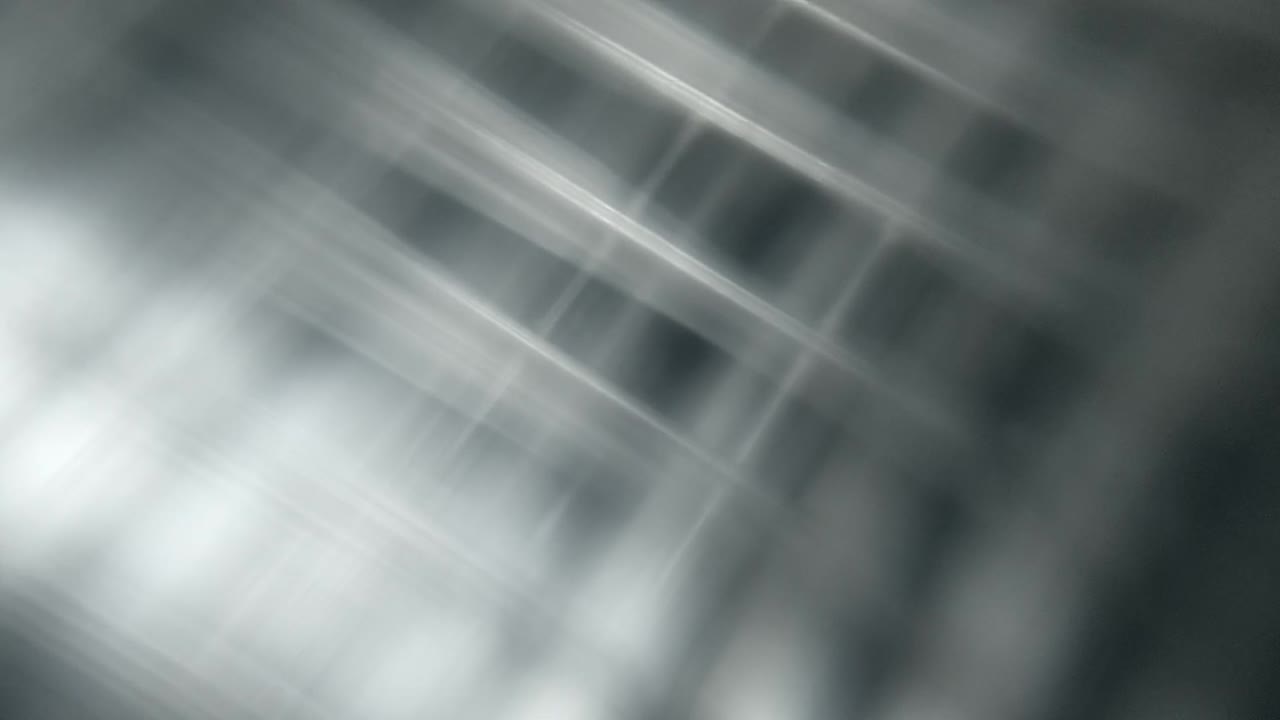 Surreal lines moving and flowing past of a stainless steel grill ...