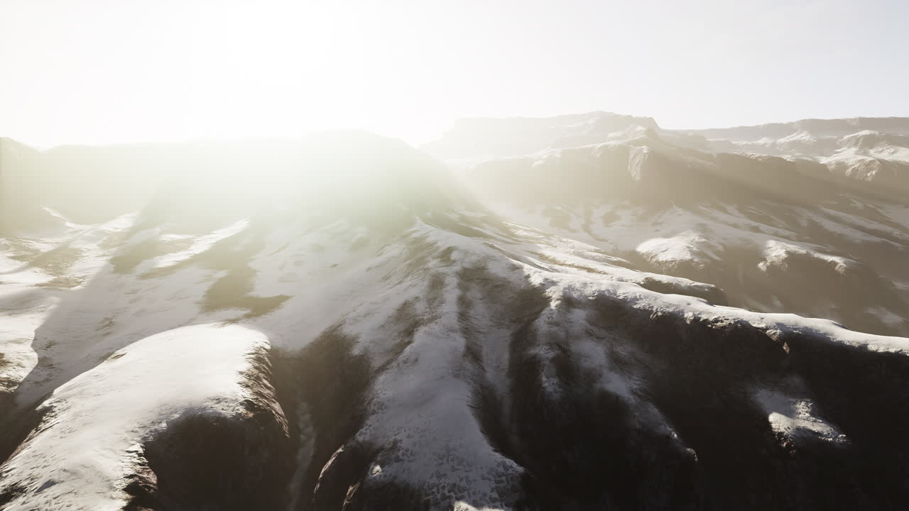 Free stock video - Snowy mountains with deep ravine and rock cliffs