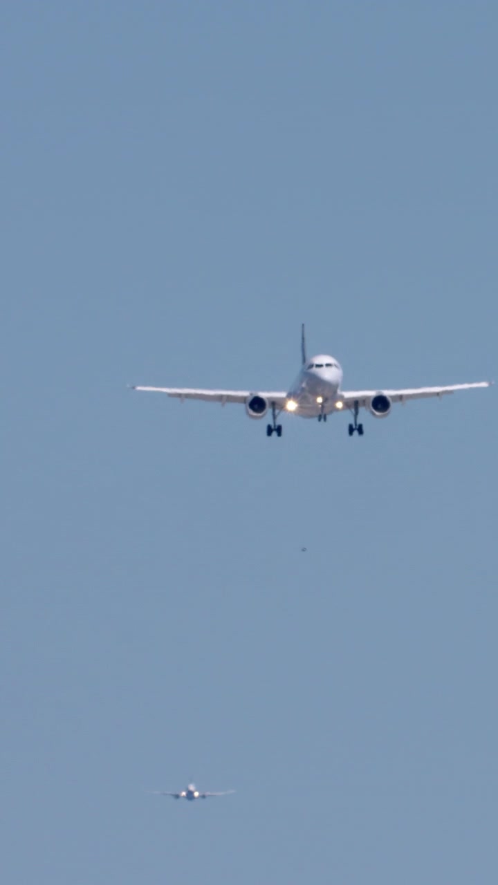 Premium stock video - Airplane landing at barcelona airport in vertical