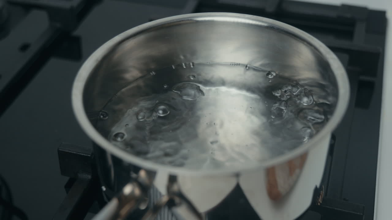 Premium stock video - Rapid boiling water in a pot on a gas stove