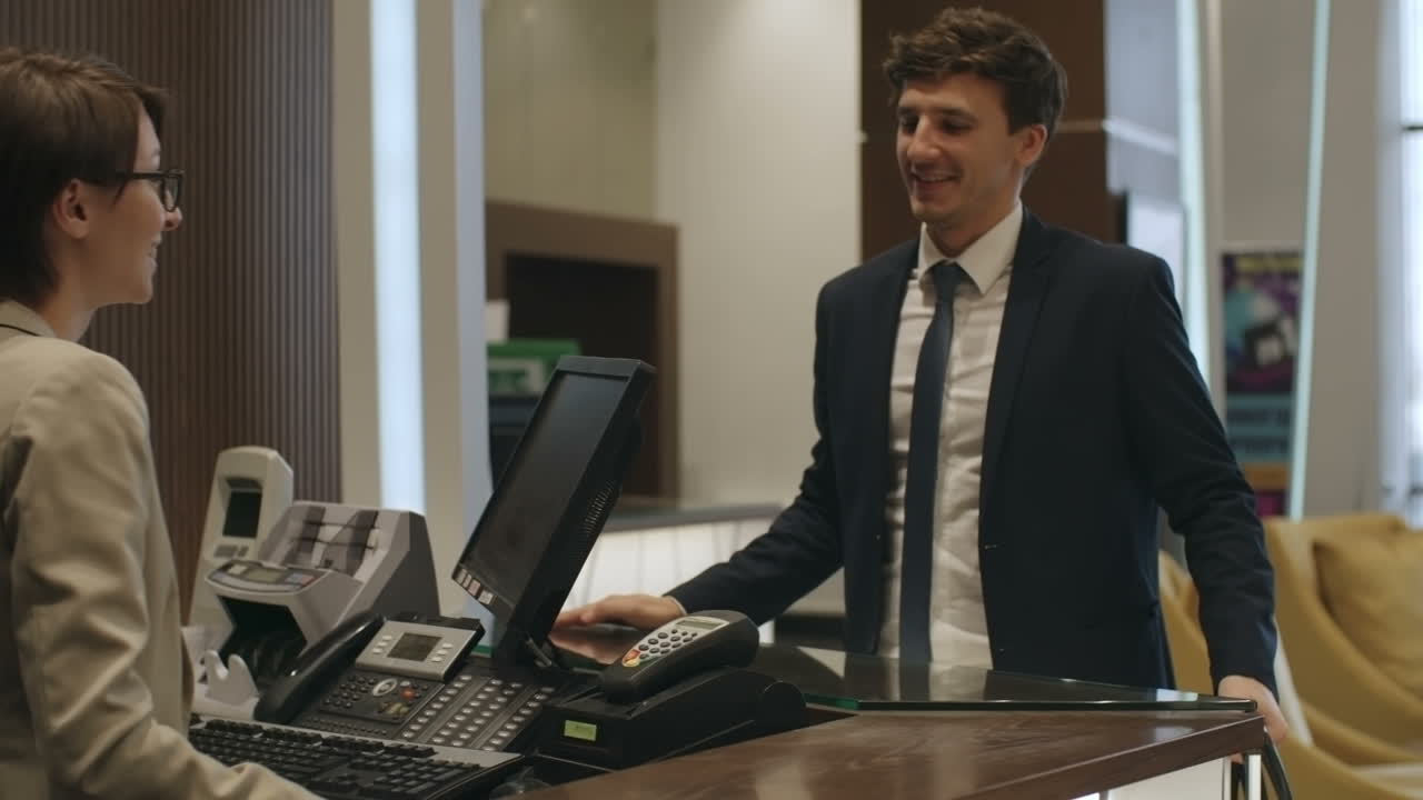 Free stock video - Businessman at a hotel reception