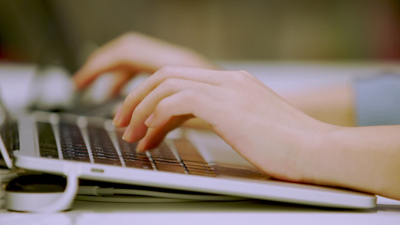 Premium stock video - Computer programmer typing code on a flat keyboard