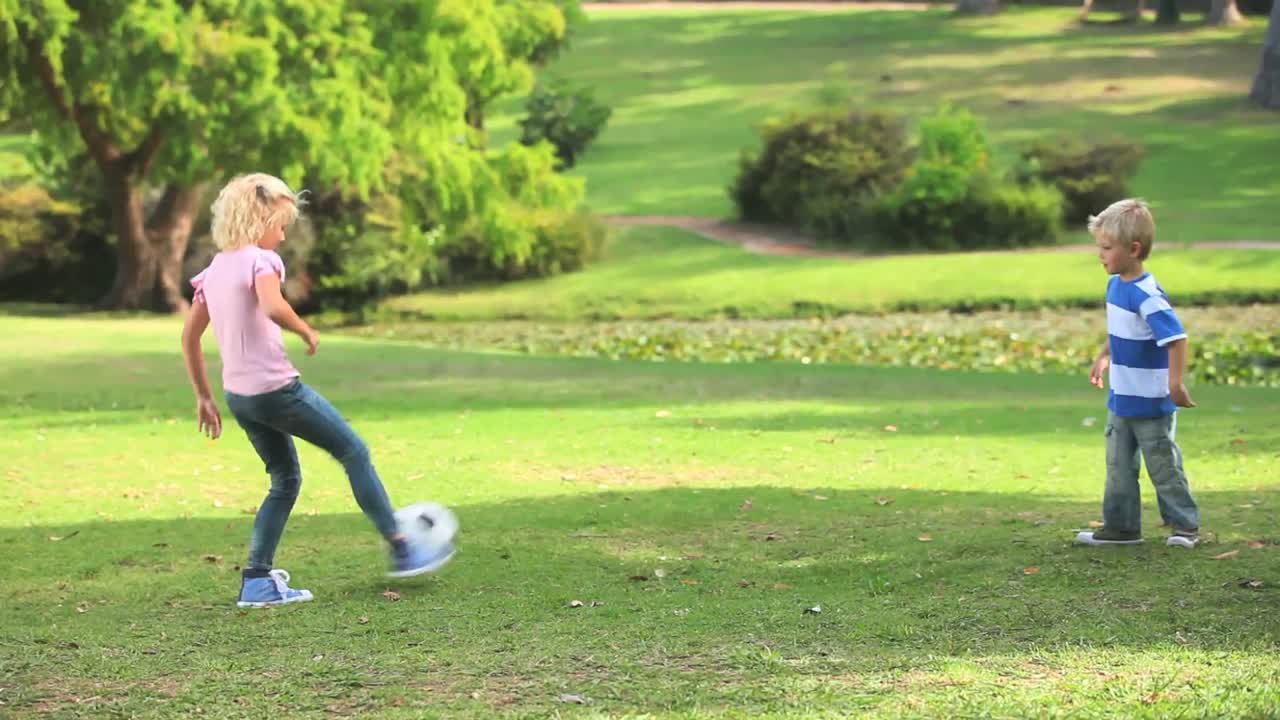 Young boy and his sister playing together with a ball Premium Stock ...