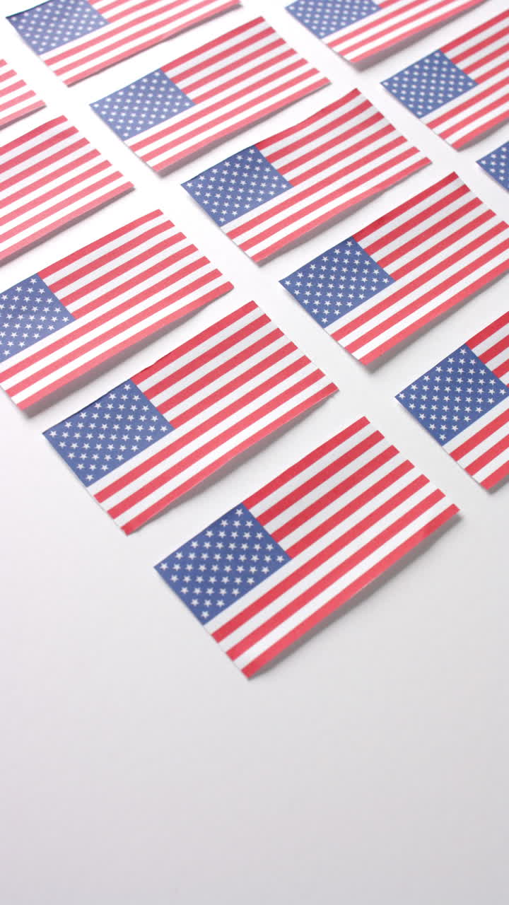 Vertical video of multiple national flags of usa lying with copy space ...