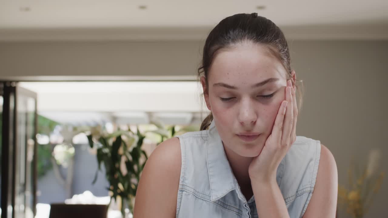 Premium stock video - Caucasian teenage girl making video call looking ...