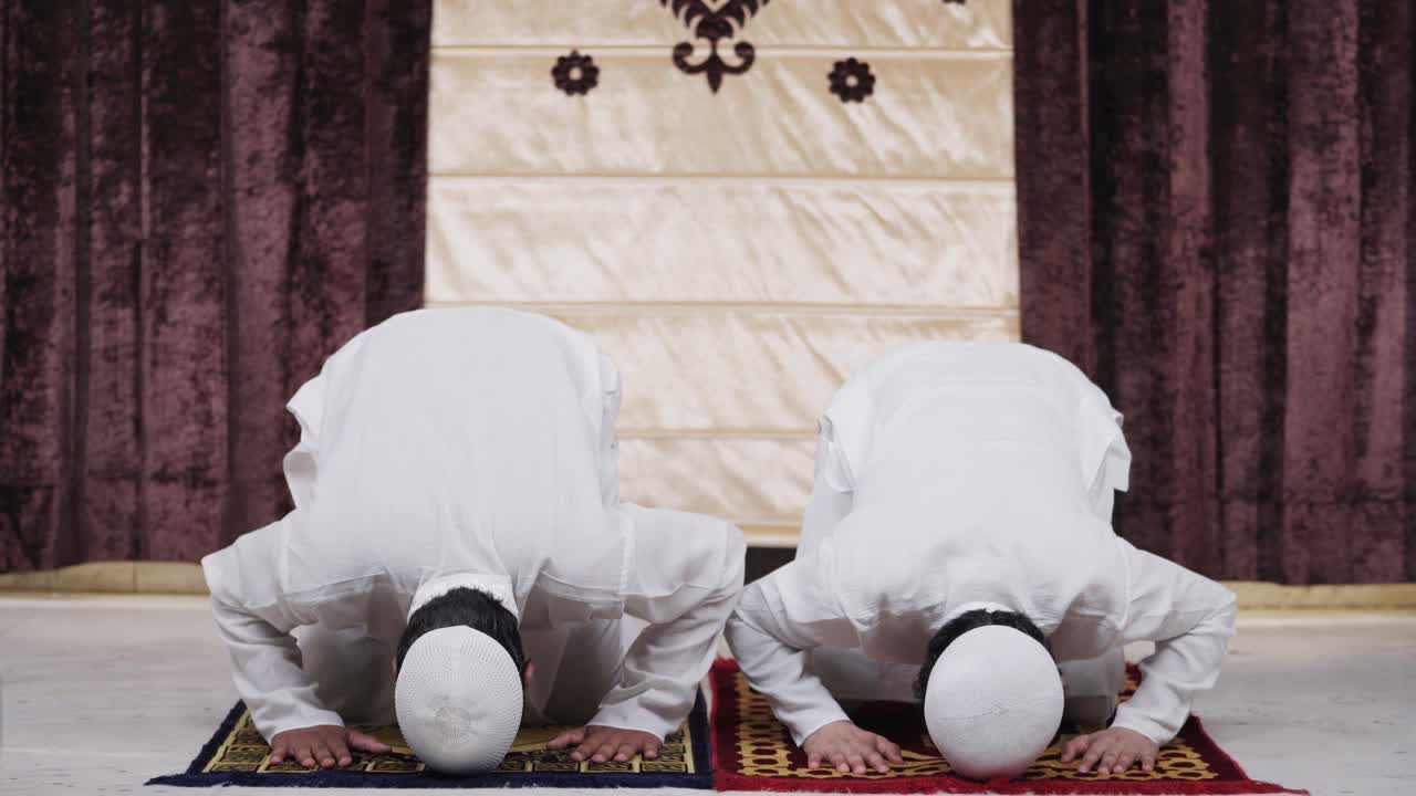 Premium stock video - Muslim men doing sujud prayer at home