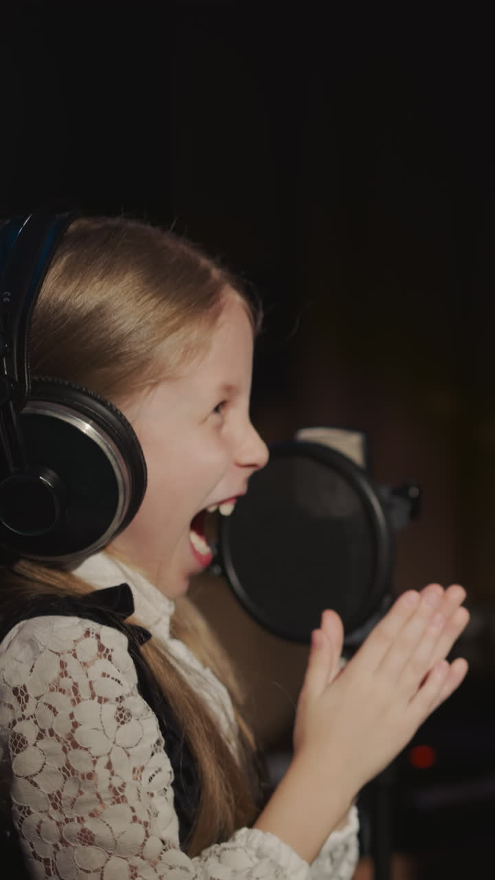 Vocal teacher entertains student in audio studio. Team of girl and ...