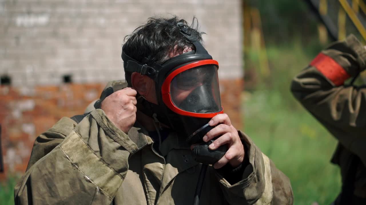 Firefighter donning gas mask Premium Stock Video Footage
