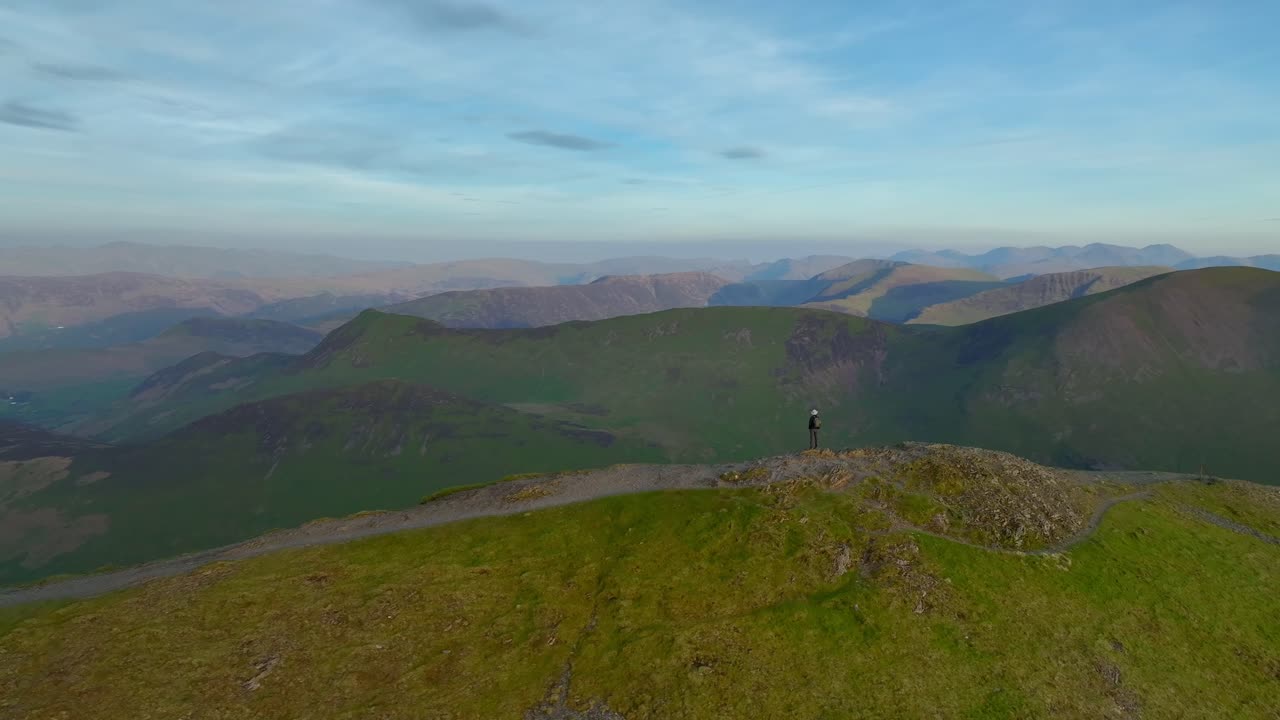 Premium stock video - Lone mountain walker on fell path summit at ...