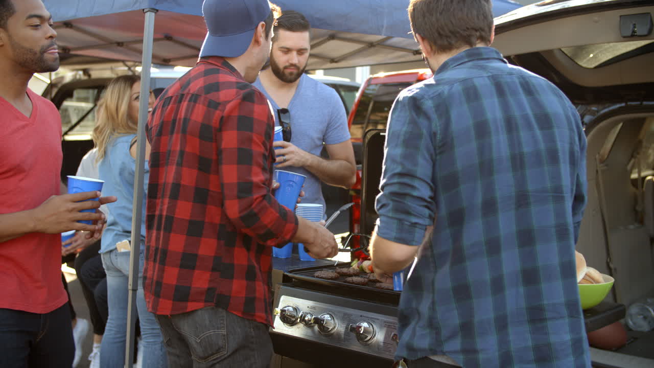 Premium stock video - Slow motion shot of sports fans tailgating in ...