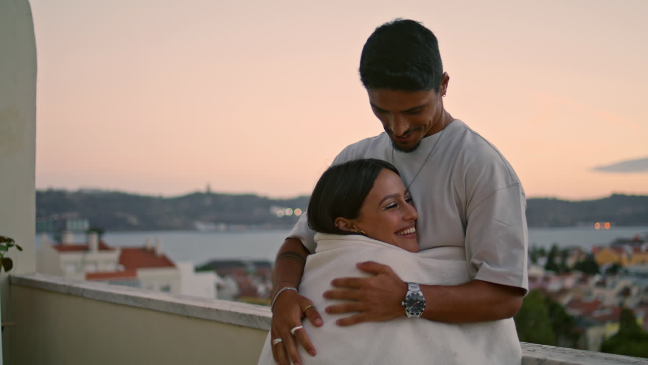 Affectionate people embracing sunset terrace together. pair bonding in ...
