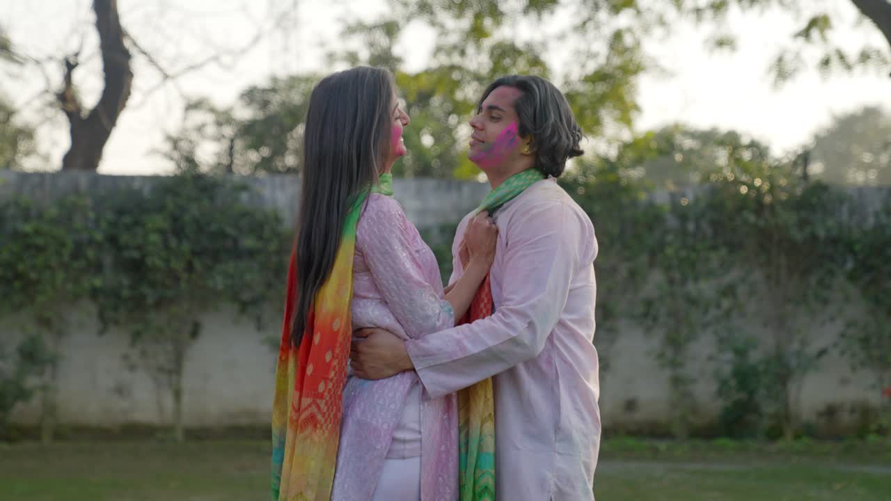 Romantic Indian couple hugs at a Holi party | Premium Stock Video Footage