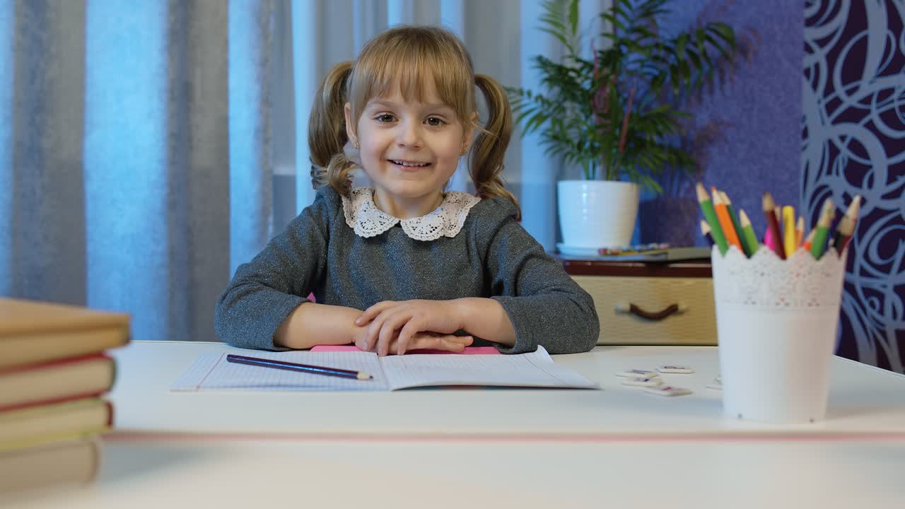 Premium stock video - Child girl pupil looking at web camera making ...