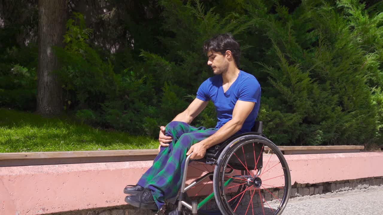 Disabled teenager sitting in a wheelchair. Premium Stock Video Footage