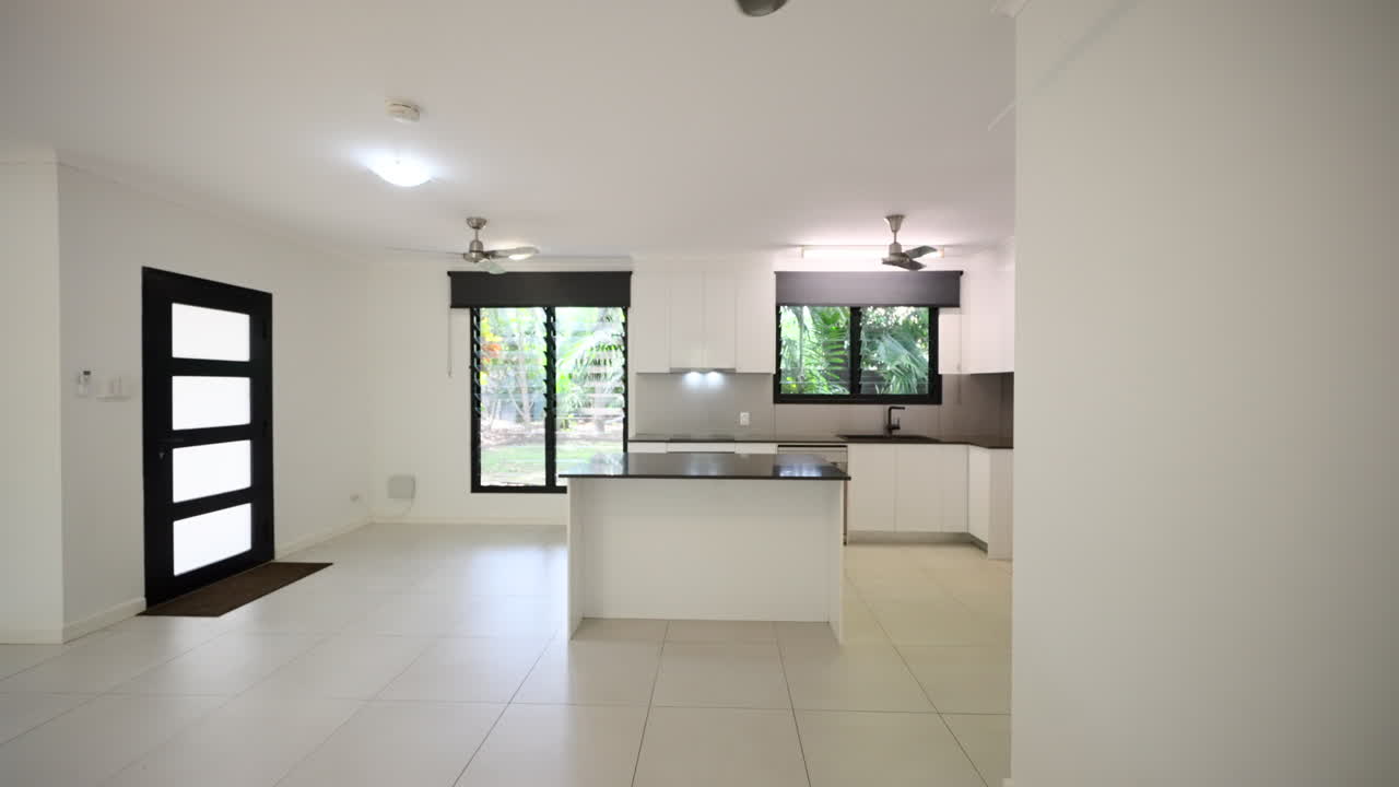 Premium stock video - Open kitchen with black stone island bench top ...
