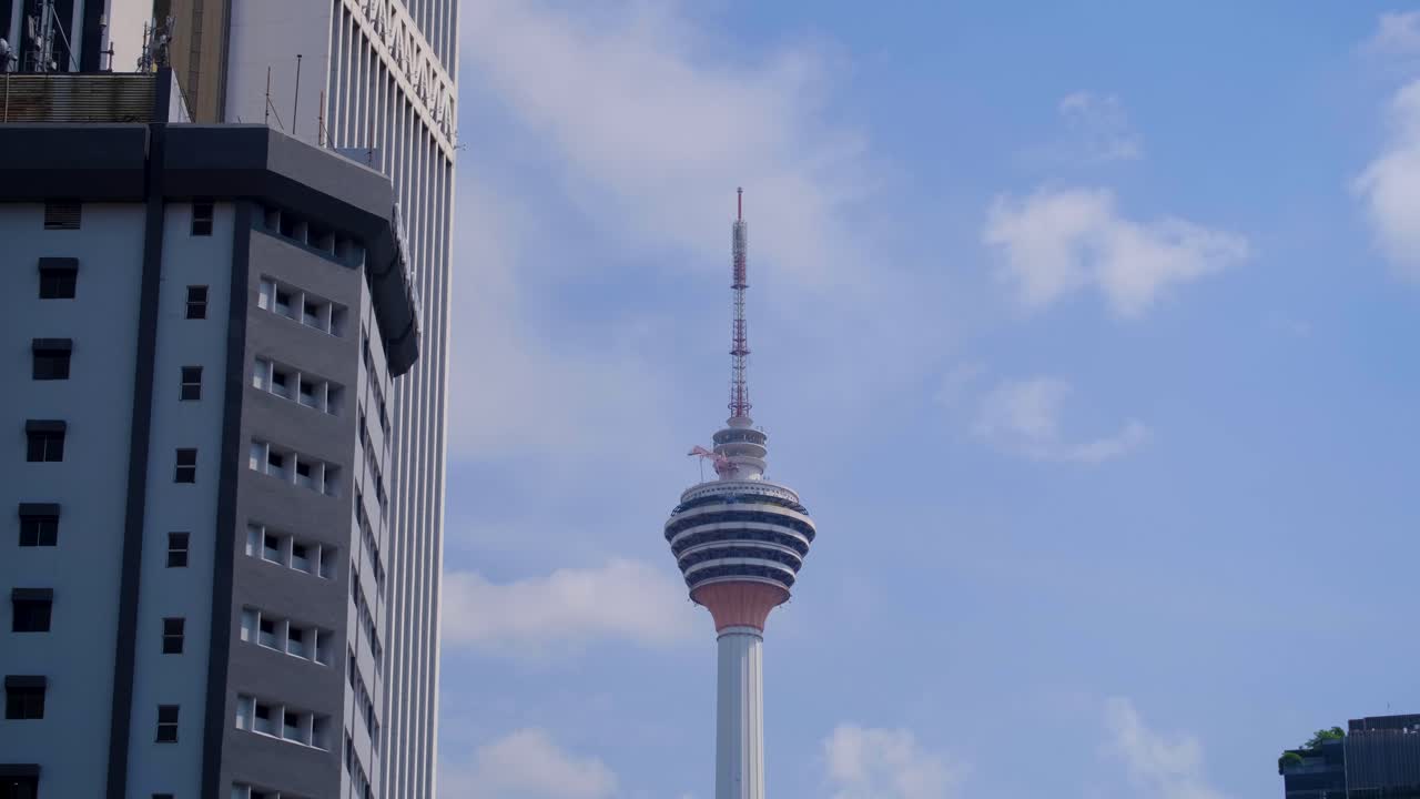 Urban view of Menara tower landmark against blue sky in capital city of ...