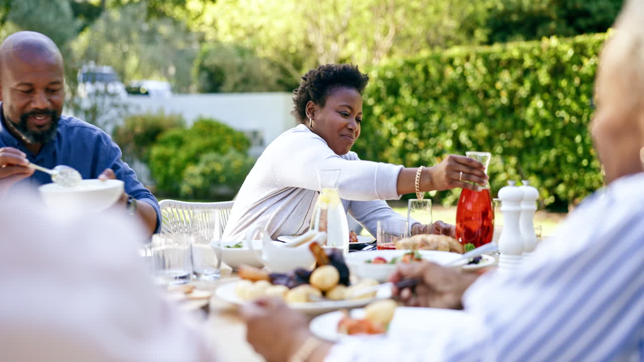 Premium stock video - Family, lunch and talking in garden