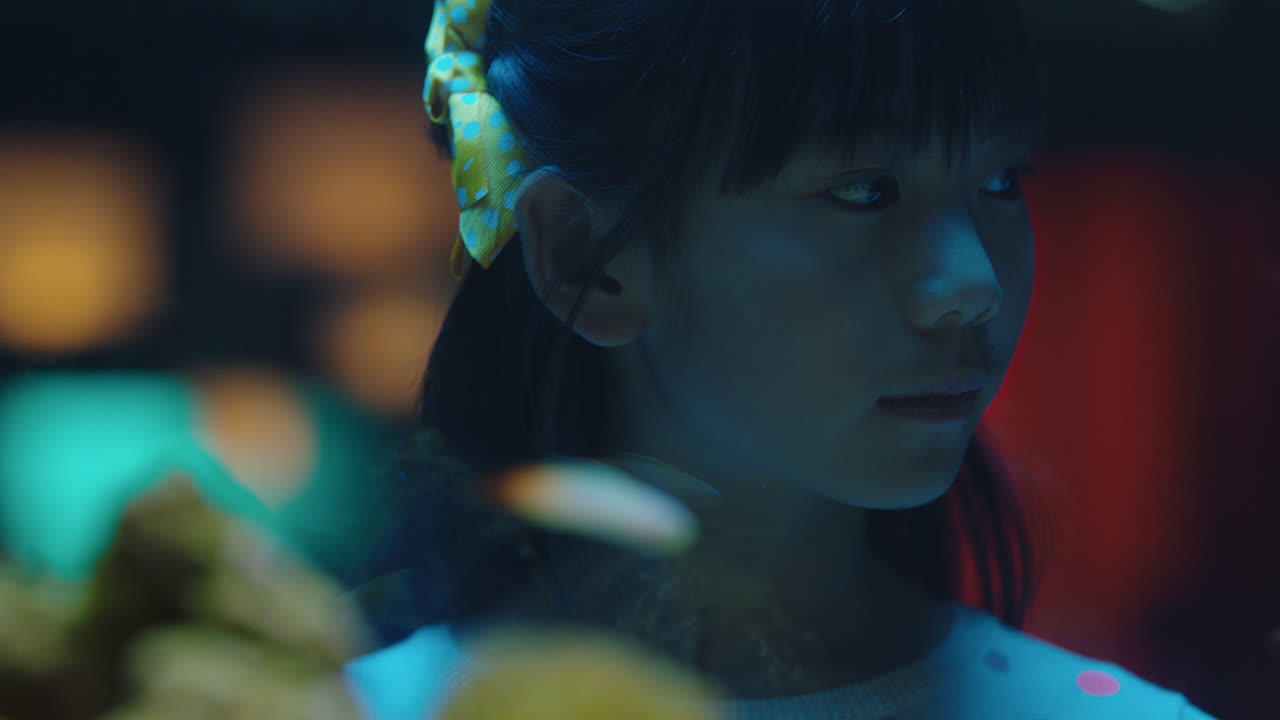 Asian girl looking at fish in aquarium curious child watching colorful ...