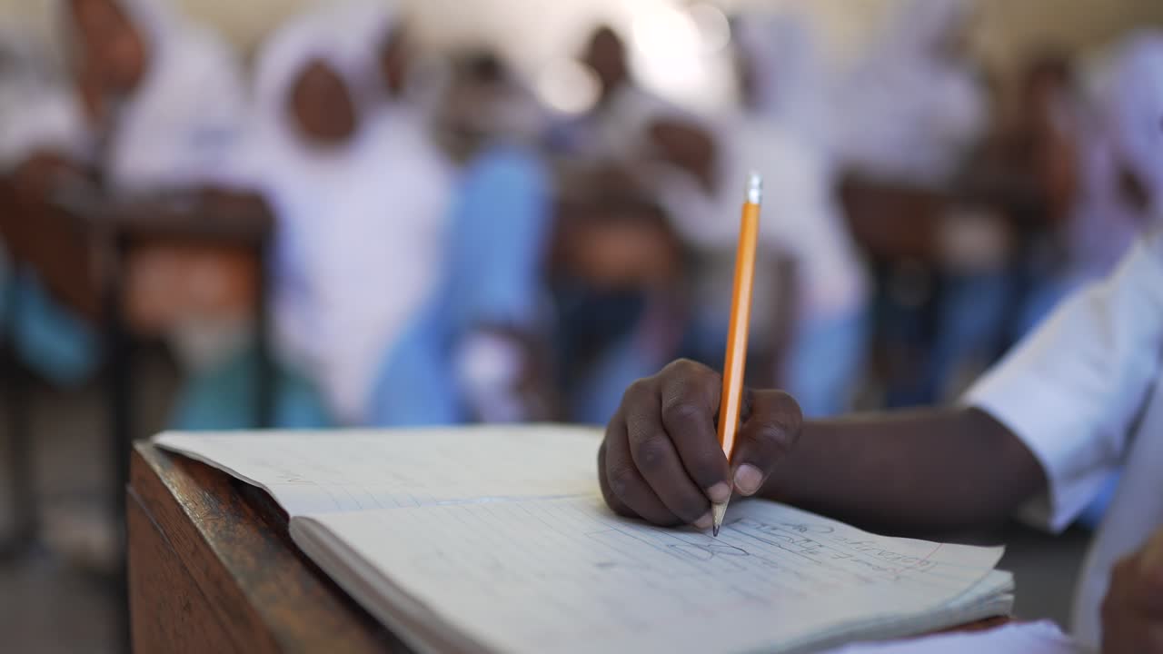 Close Up Cinematic Shot Of A African Black Kid With A Pencil Writing ...