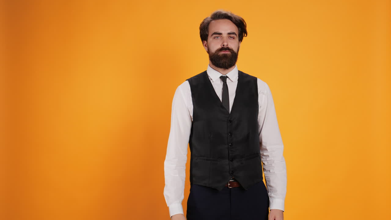 Premium stock video - Elegant butler points up on camera