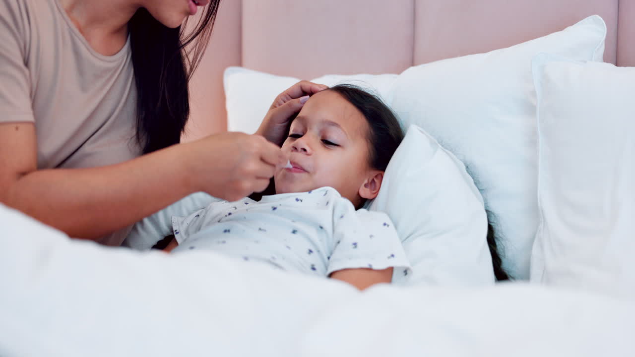 Mom, sick child in bed with thermometer for cold Premium Stock Video Footage