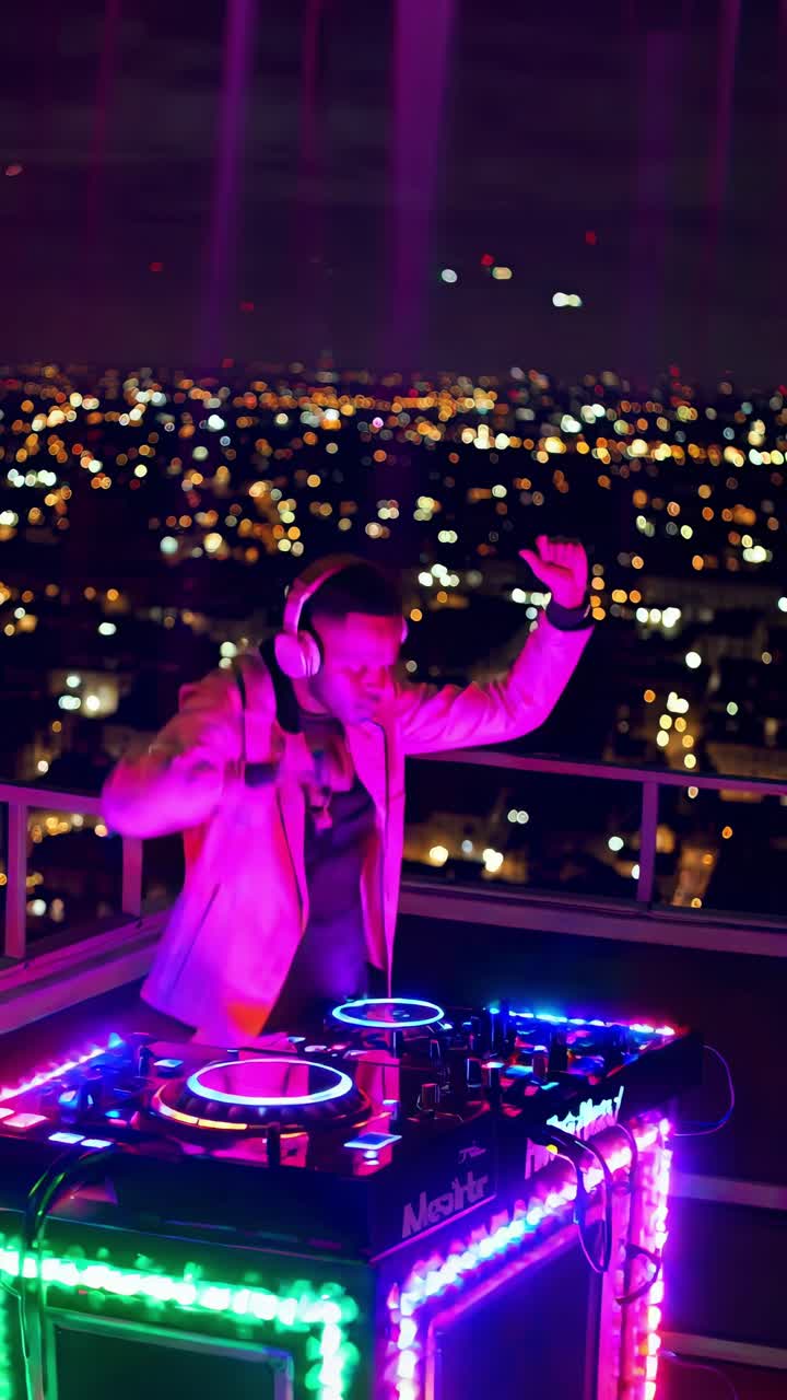 Professional disc jockey mixing vibrant music on a DJ set, surrounded ...