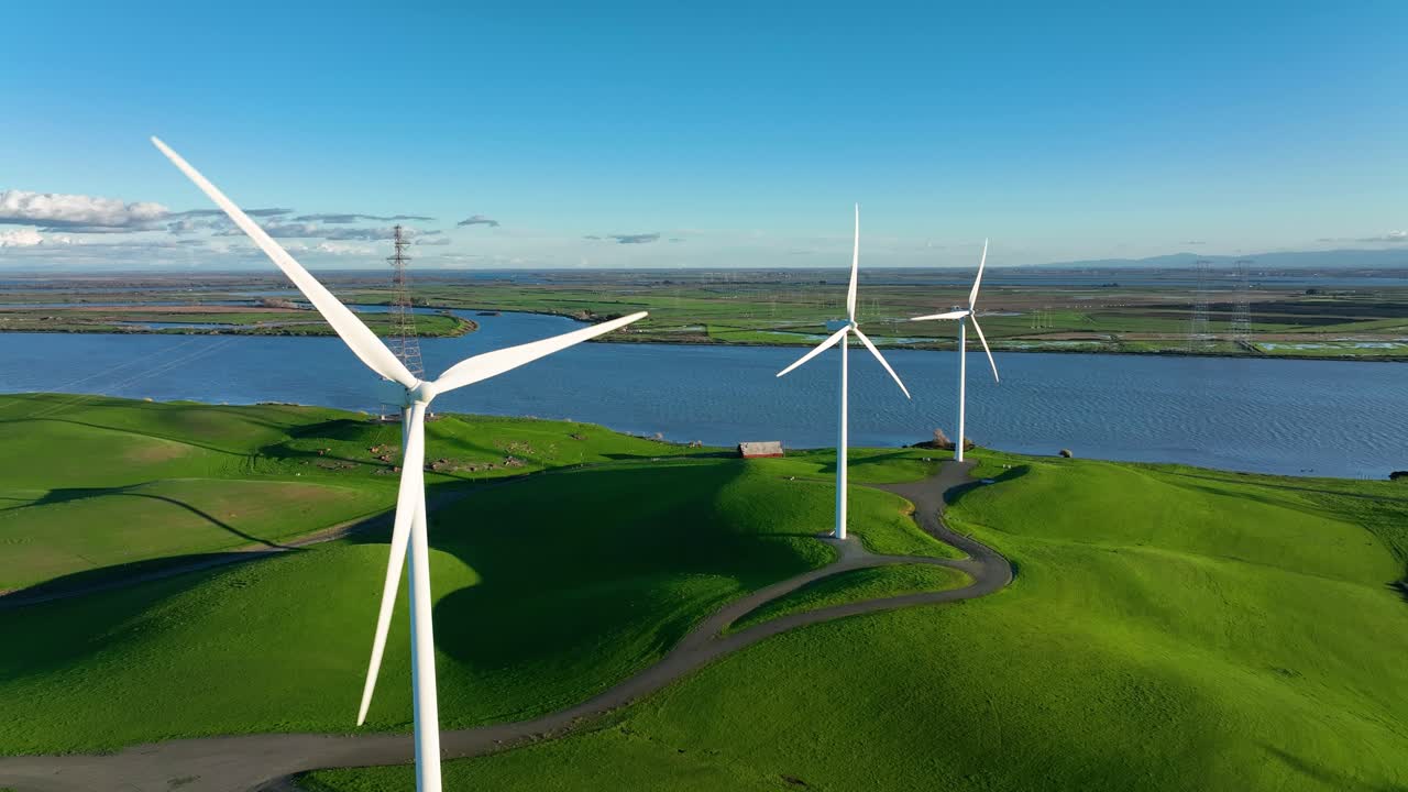 Premium stock video - Wind turbines producing energy on green hills ...