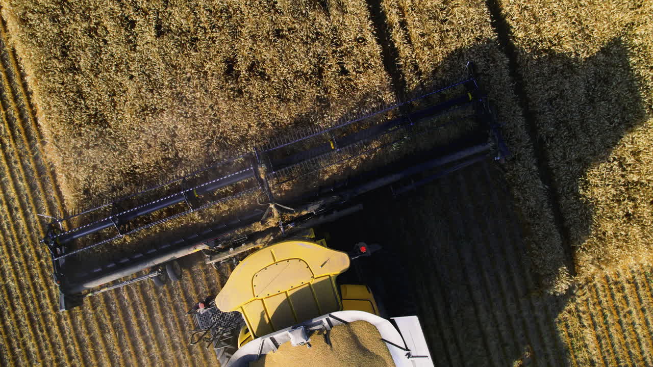 Premium stock video - Arcing aerial overhead view of combine harvester ...