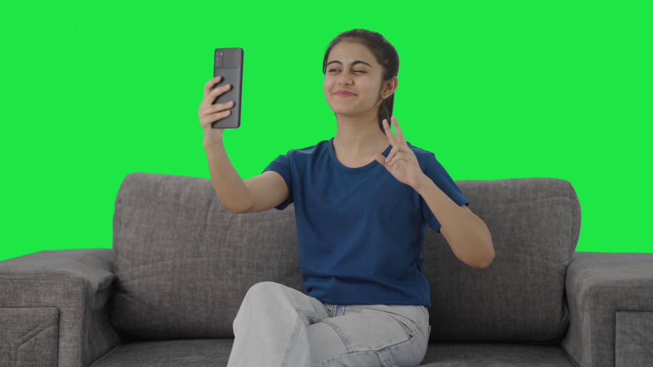 Happy indian teenage girl clicking selfies green screen Premium Stock ...