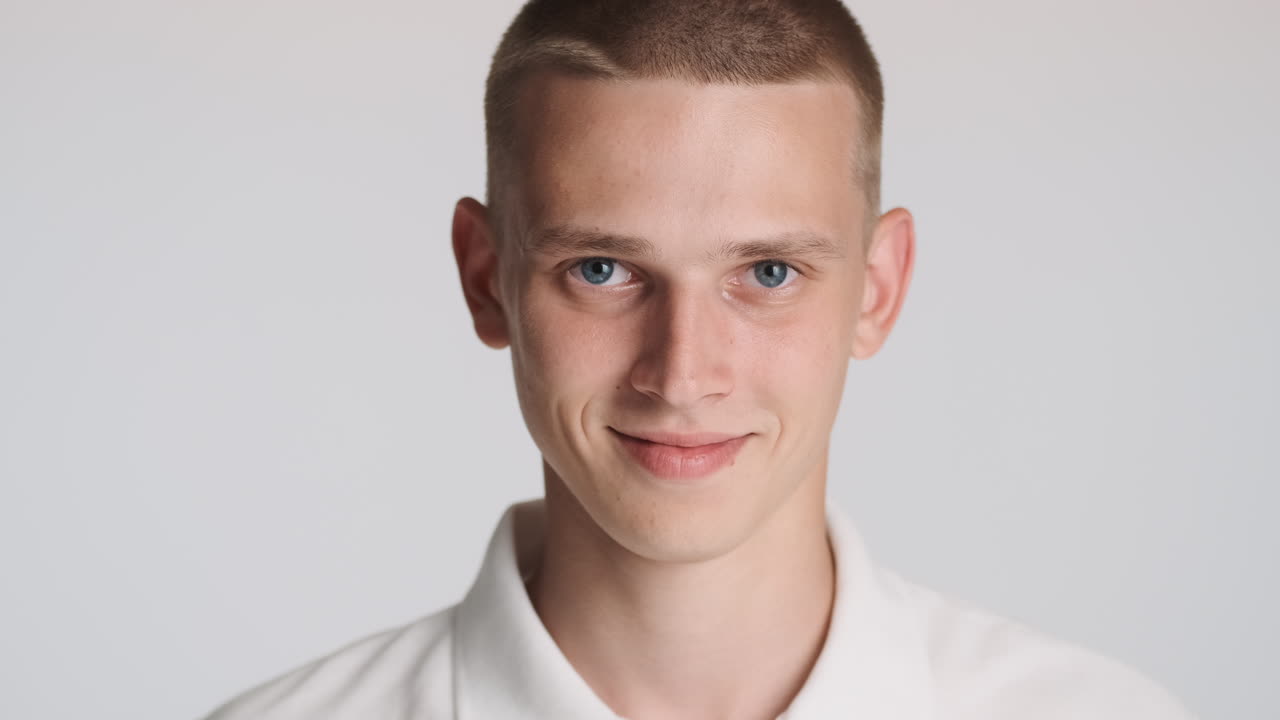 Free stock video - Smiling young guy looking at camera