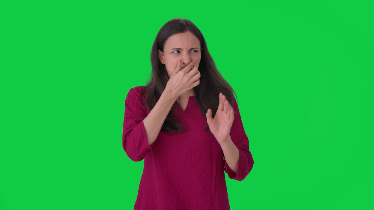 Indian woman getting disturbed by bad smell Green screen | Premium ...