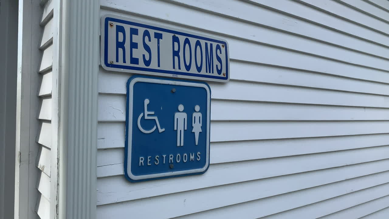 Premium stock video - Restroom sign on the side of a public building in ...